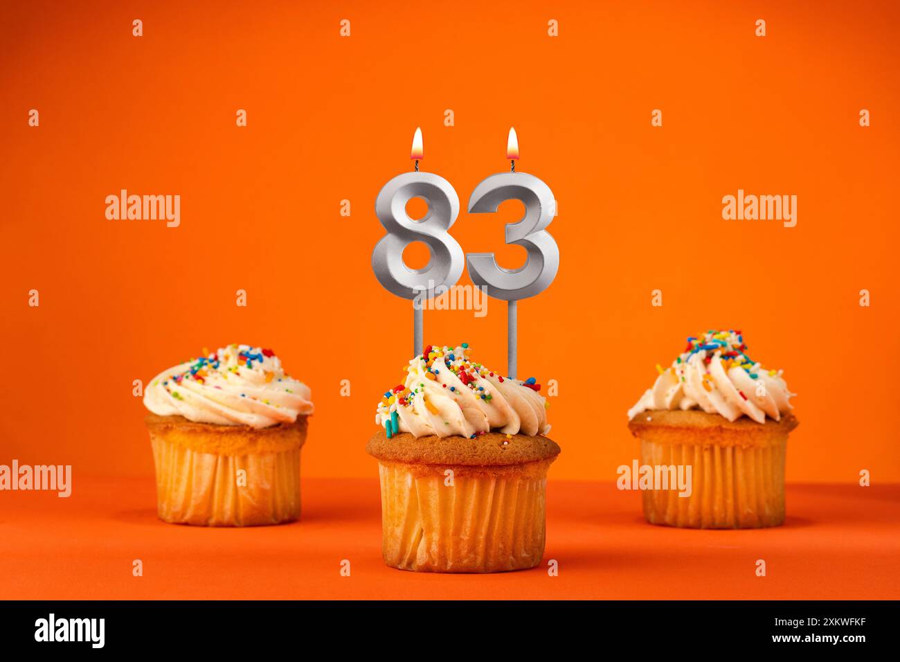 Candle number 83 - Celebration with birthday cupcake on orange ...