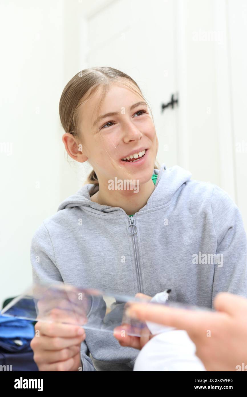 Girls doing maths math sitting on floor writing on whiteboard with pens ...