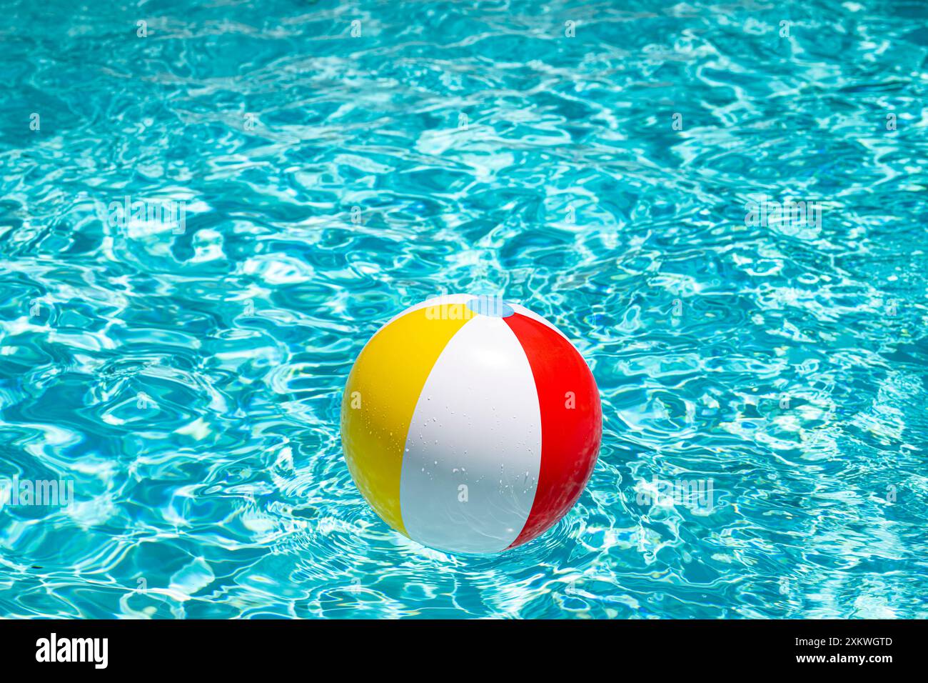 Beach ball floating in swimming pool. Advertising for summer vacations ...