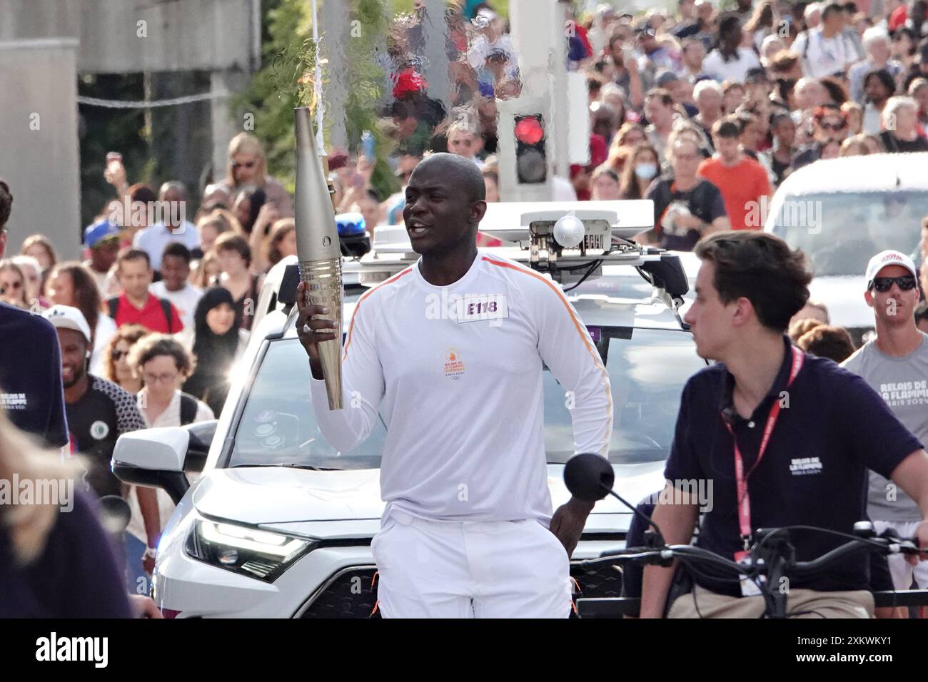 Paris, France. 24th July, 2024. A torch bearer carries the Olympic ...