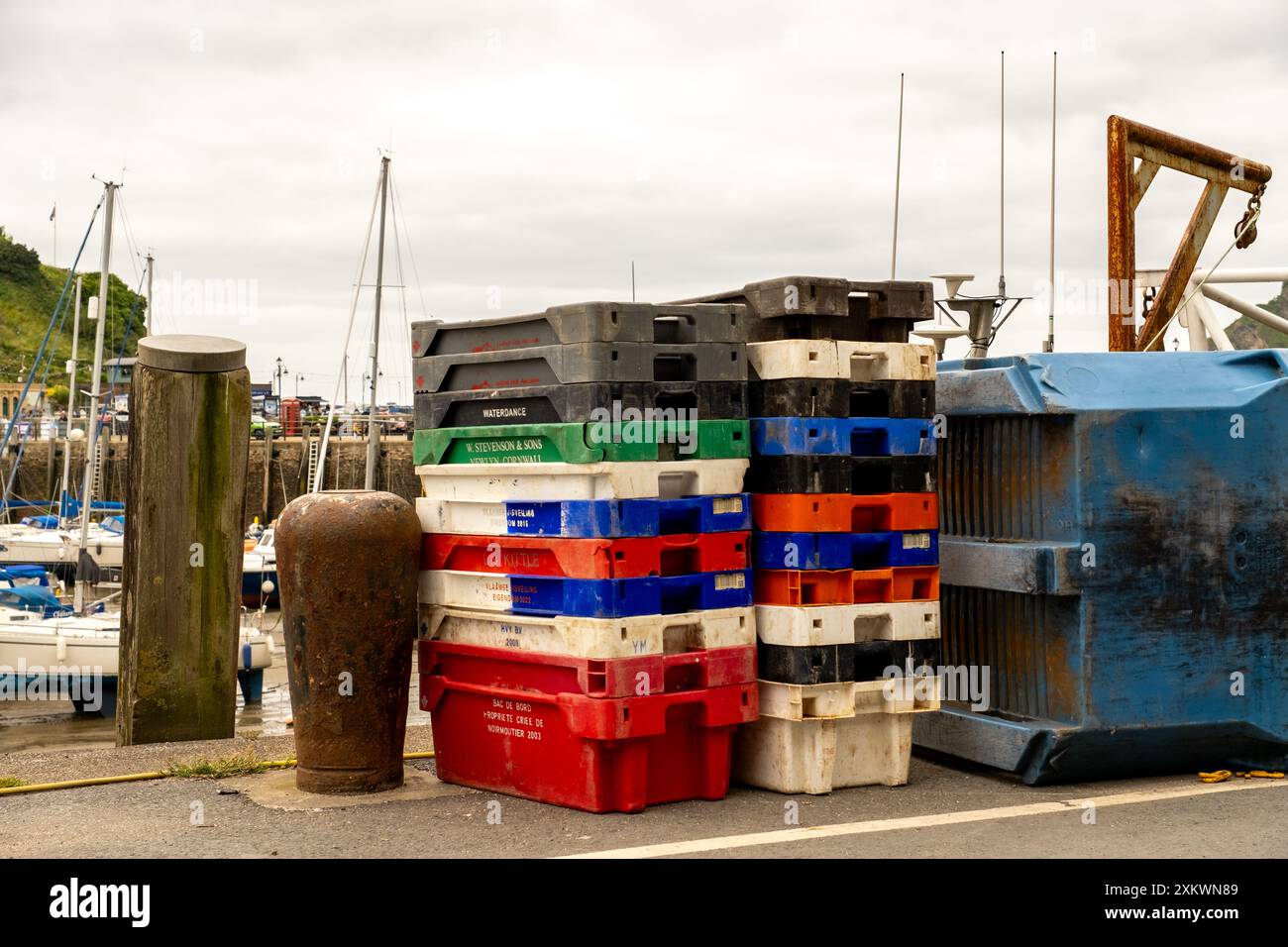 Plastic fish crates and fishing equipment on the quayside in Ilfracombe ...