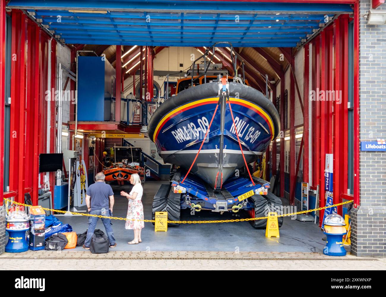 Front on view of the RNLI lifeboat in its shed in the harbour Stock ...