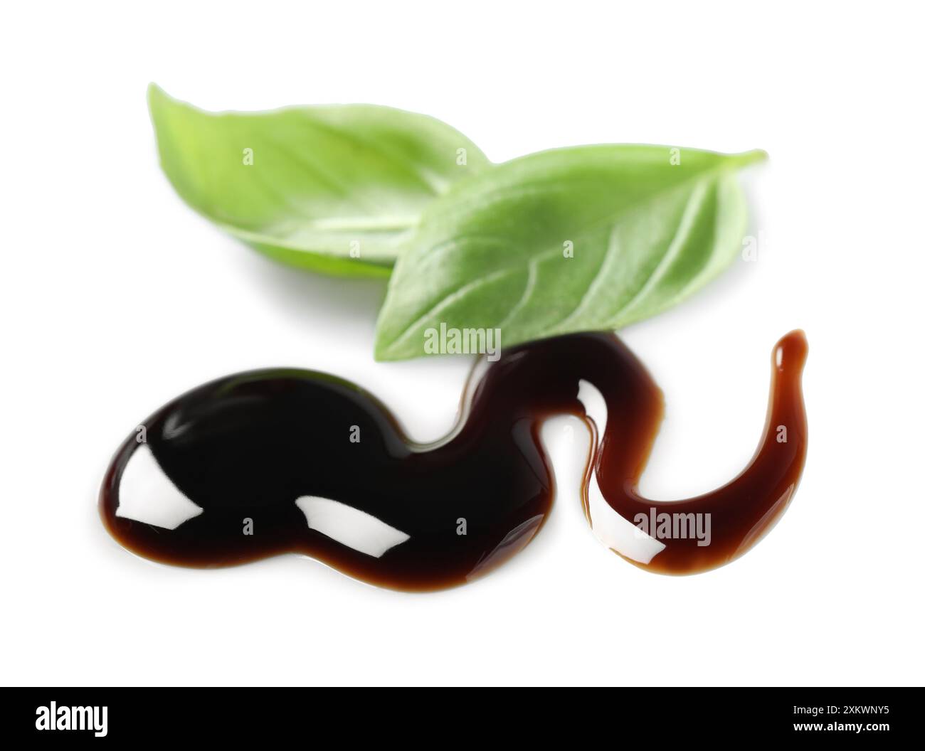 Delicious balsamic vinegar and basil leaves isolated on white Stock ...