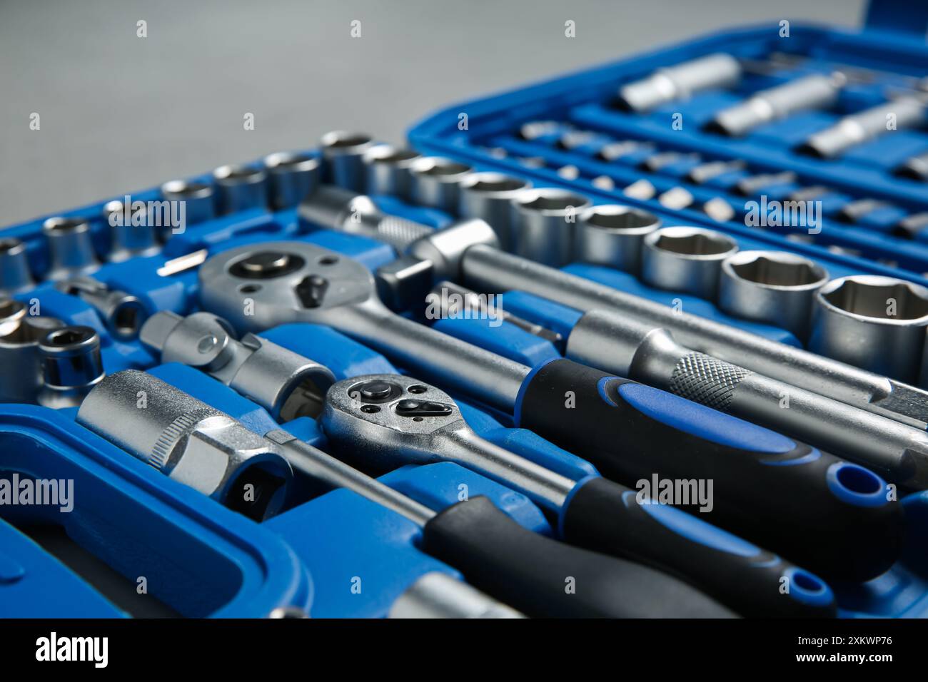 Different auto mechanic's tools in plastic box on grey table, closeup ...