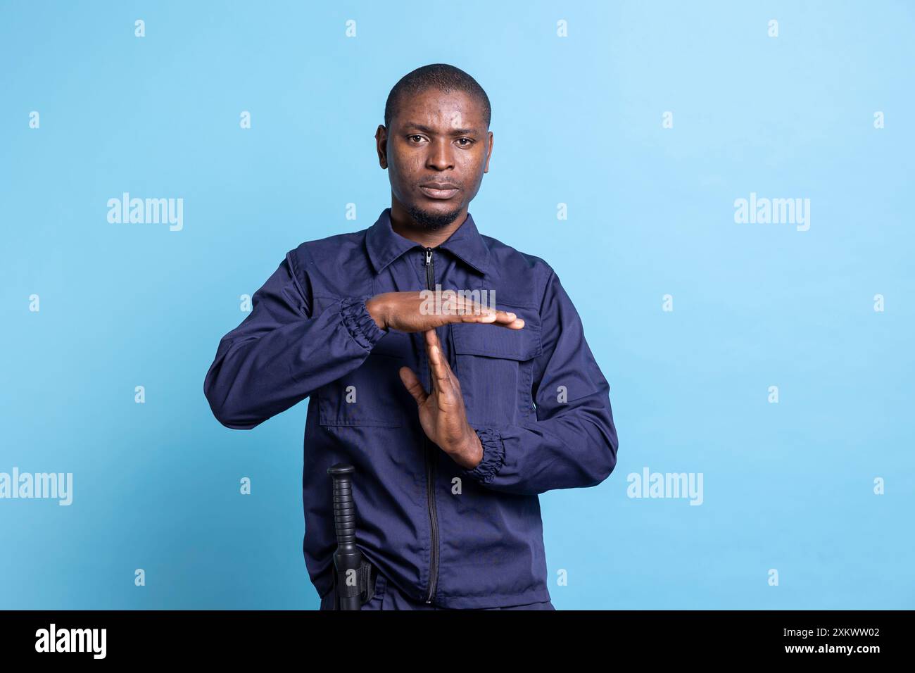 Patrol agent showing a timeout gesture against blue background, asking ...