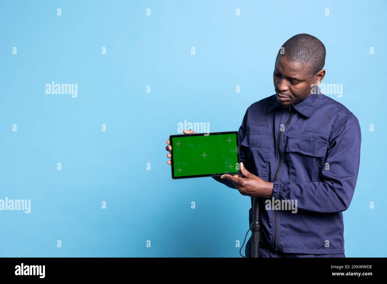 Employee shows greenscreen on tablet hi-res stock photography and ...