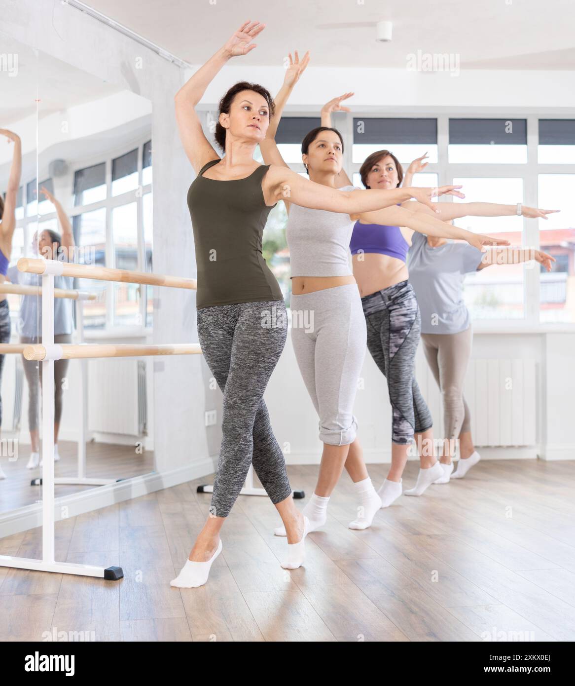 Woman practicing ballet moves during amateur group class Stock Photo ...