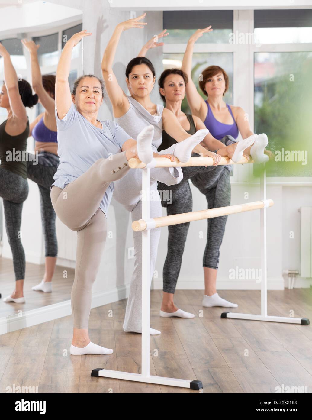 Ballet pose grand batman - women of different ages at choreography ...