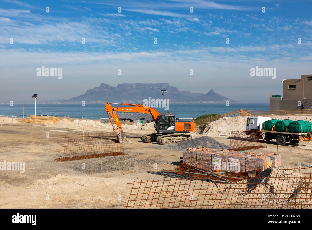 Beach construction site in Cape Town with a Hitachi excavator, water ...