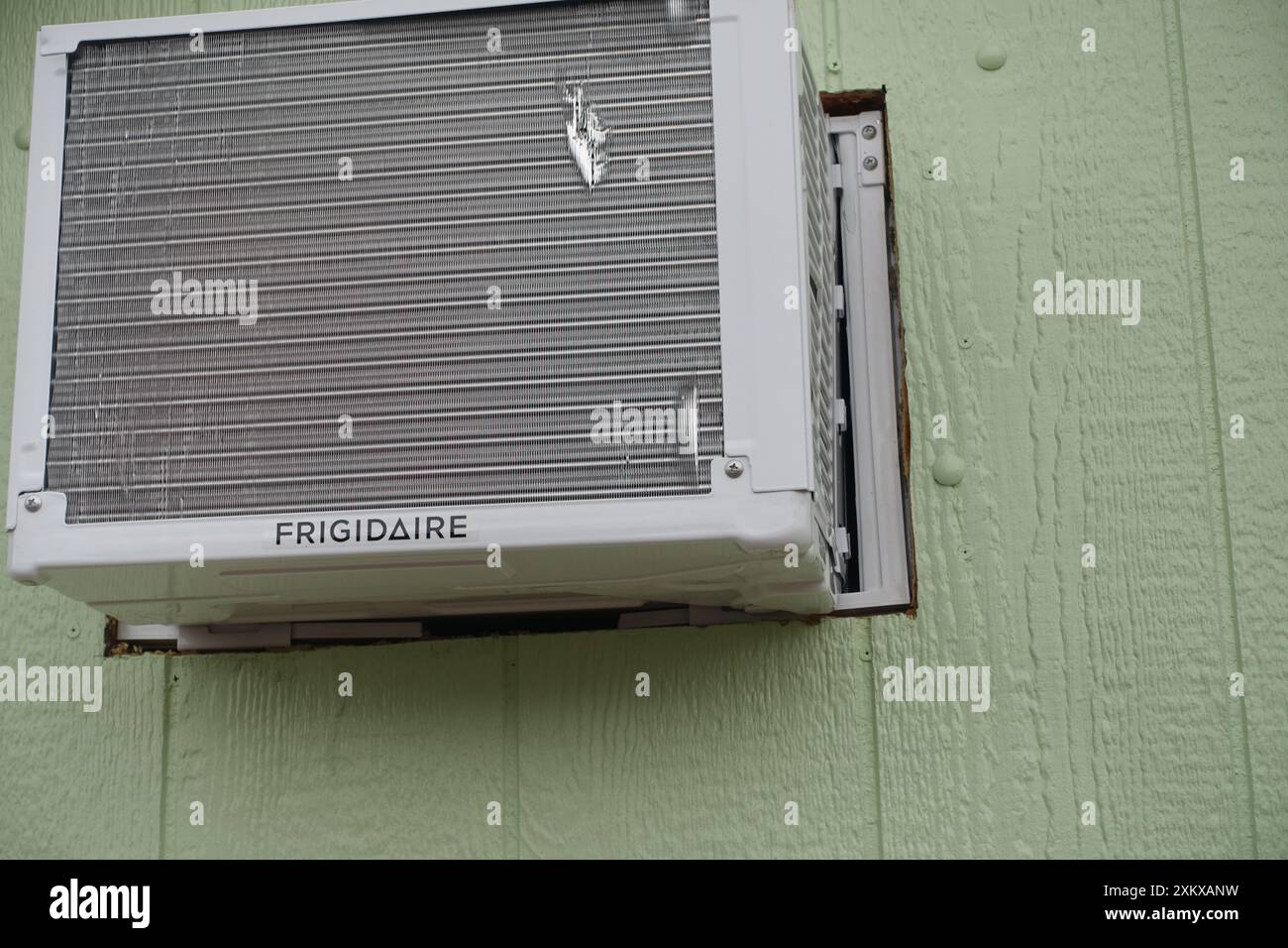 A window mounted AC unit fitted in a wall opening Stock Photo - Alamy