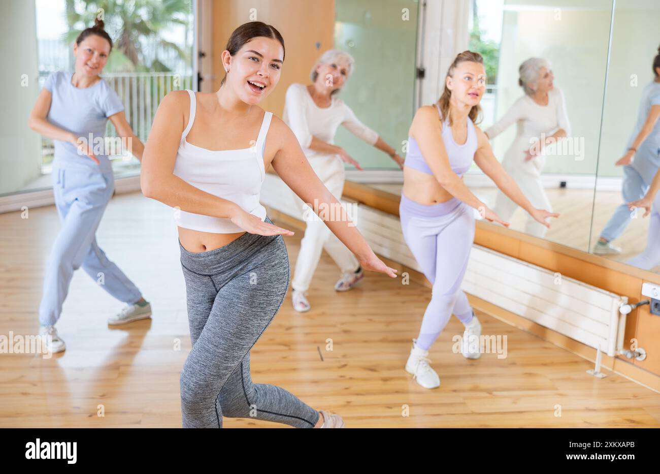 Active people practicing lindy hop movements in dance class Stock Photo ...