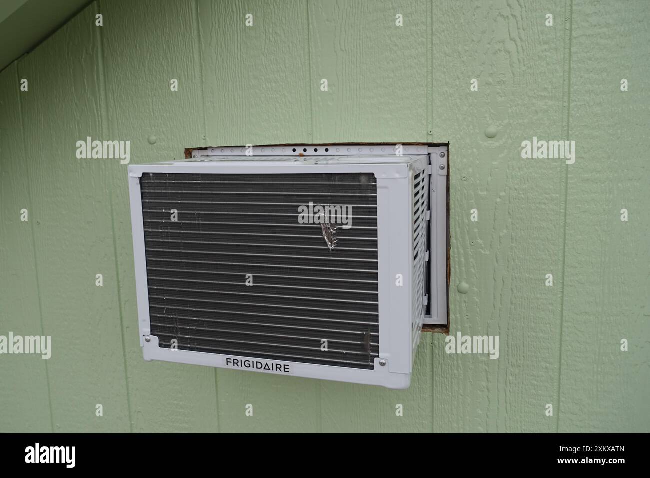 A window mounted AC unit fitted in a wall opening Stock Photo - Alamy