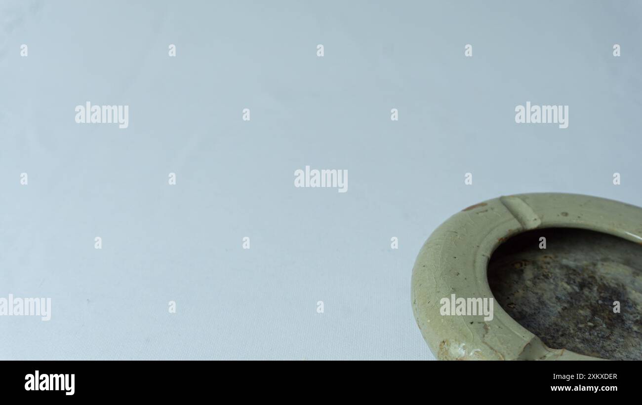 Old clay cigarette ashtray isolated on white background Stock Photo - Alamy