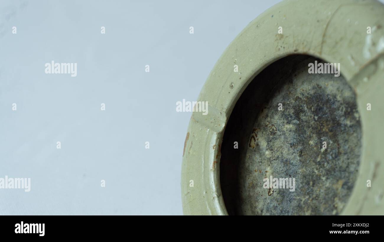 Old clay cigarette ashtray isolated on white background Stock Photo - Alamy