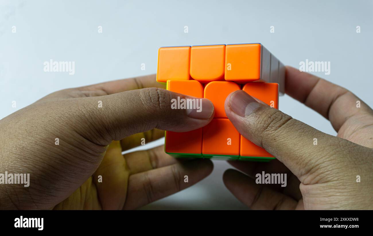 Colorful completed solving 3x3 cube being held in hand isolated on ...