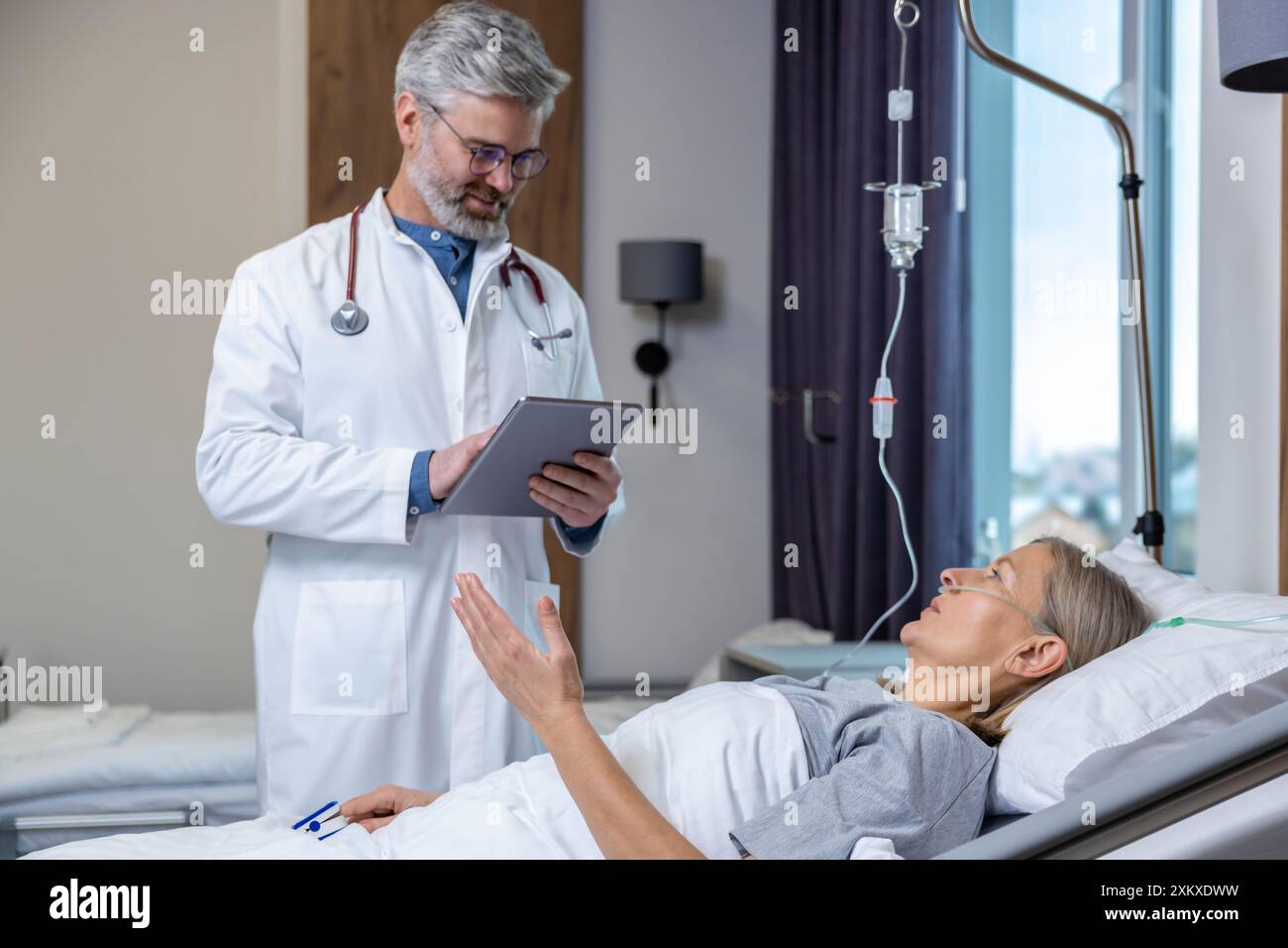 Doctor making a list of prescriptions to a patient in an intensive ...