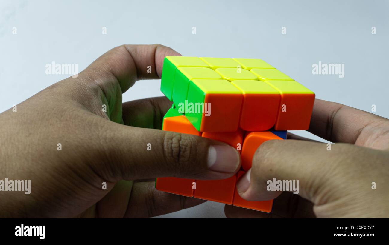 Colorful completed solving 3x3 cube being held in hand isolated on ...
