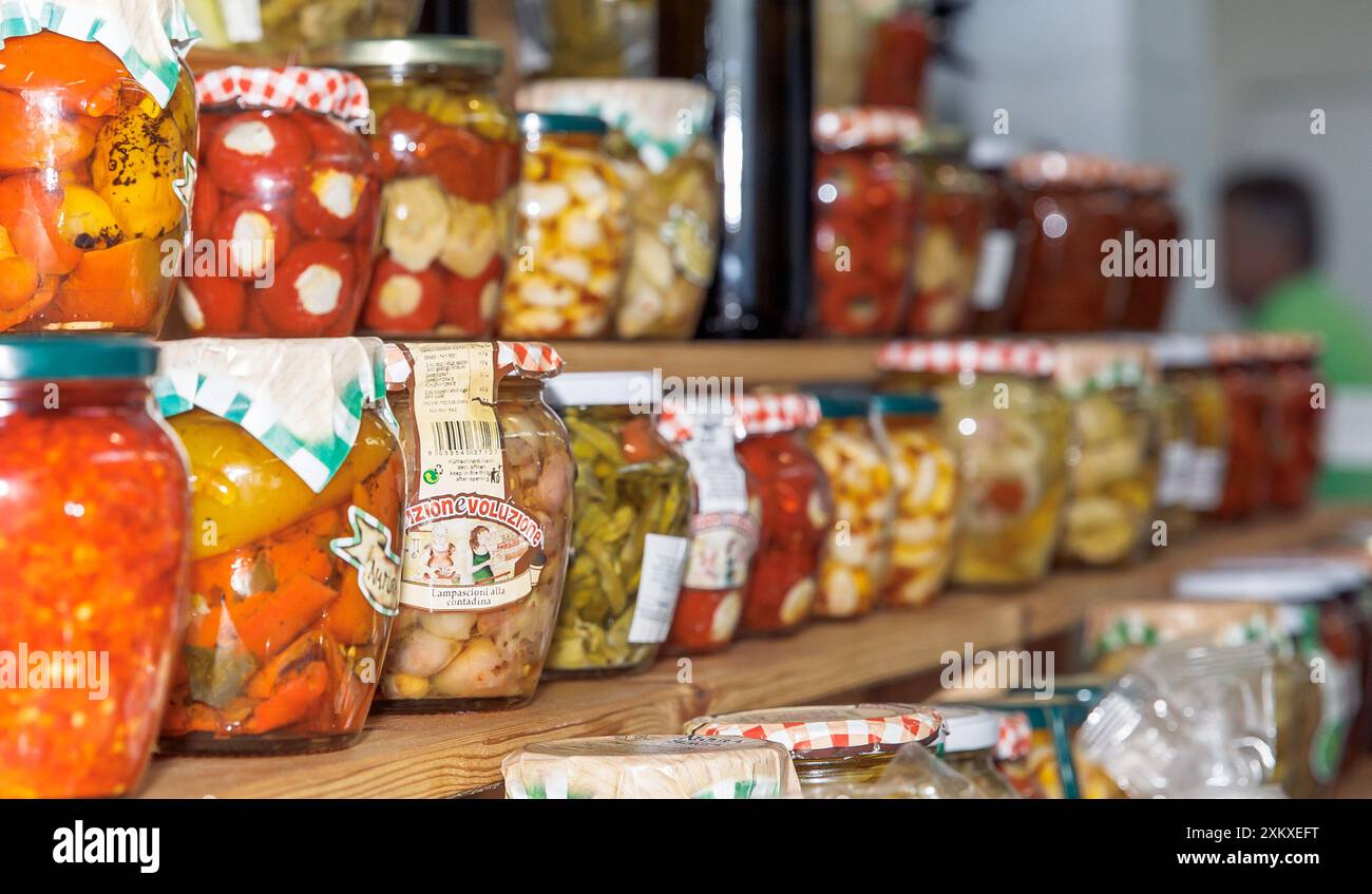 The shelves display jars of homemade pickled vegetables, peppers ...