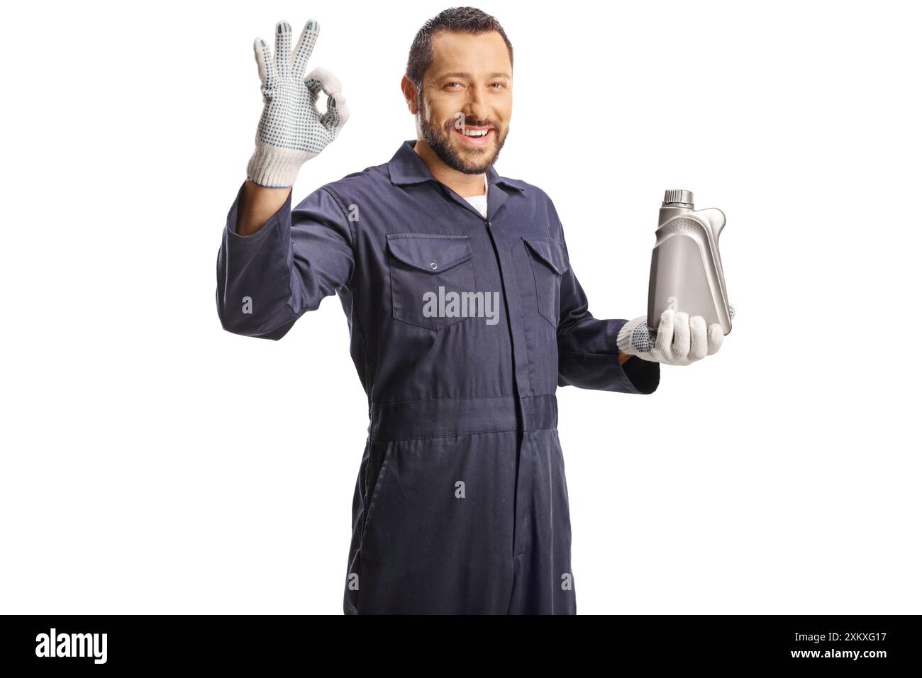 Car mechanic holding engine oil bottle and gesturing ok sign isolated ...