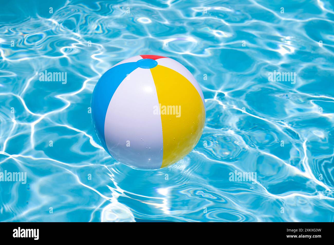 Summer swimming pool. Beach ball in swimming pool. Summer vacation ...