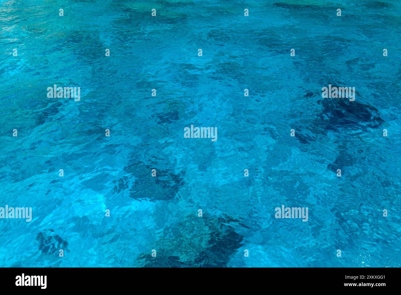 Texture of blue water under sun beams Stock Photo - Alamy