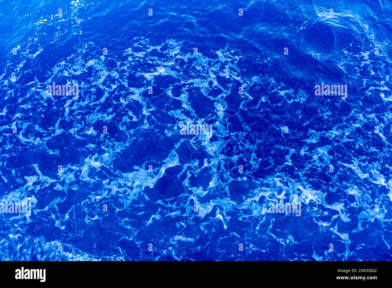 Texture of blue water under sun beams Stock Photo - Alamy