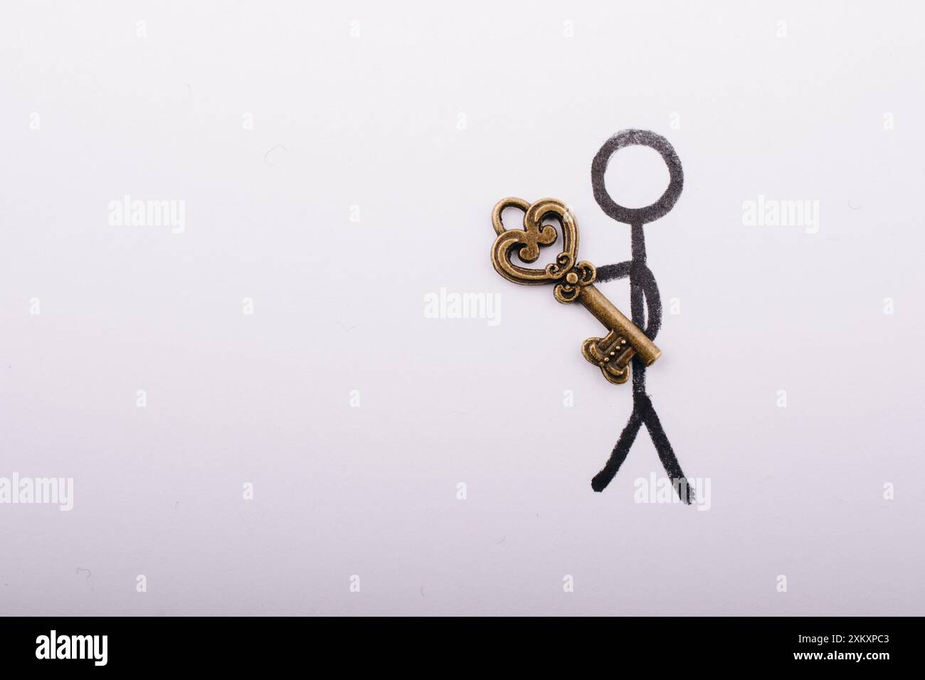 Man carrying a heart shaped key on white background Stock Photo - Alamy