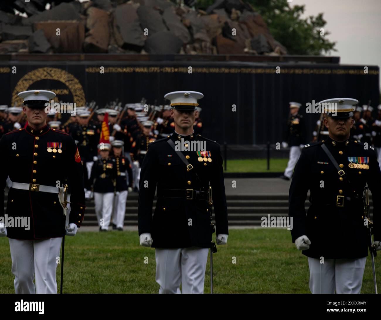 Barracks Marines march onto the parade deck during a Sunset Parade at ...