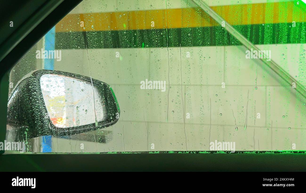 Rain-like water droplets on a car window in an automated car wash Stock ...