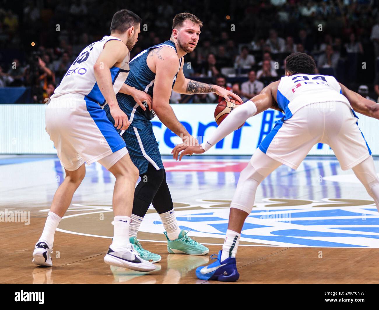 Luka Doncic (Slovenia), guarded by Giannis Antetokounmpo and Kostas ...