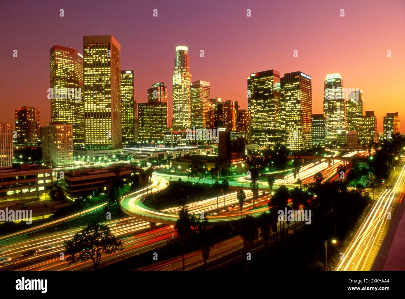The downtown Los Angeles skyline at sunset over the Harbor 110 Freeway ...