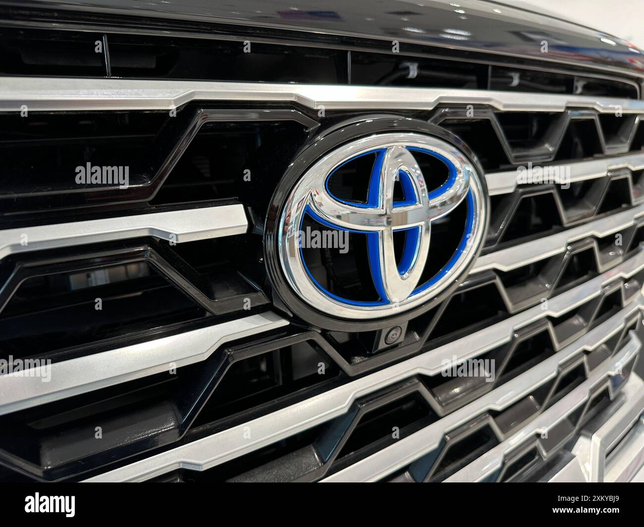 Toyota logo highlighted with blue color indicates a hybrid model Stock ...