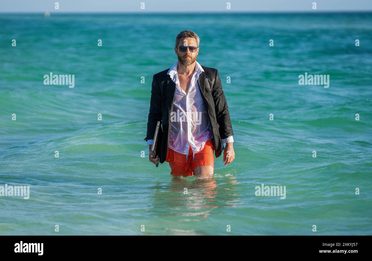 Hot business summer. business boss spending weekend at the beach ...