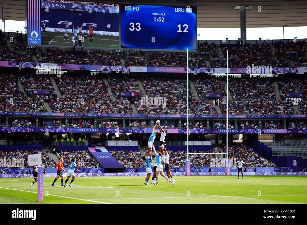 Fiji and Uruguay players compete for a line out during the rugby sevens ...