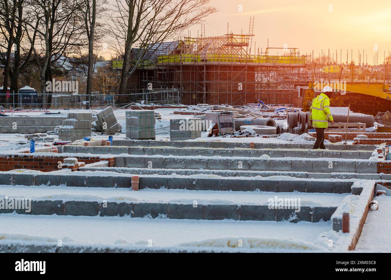 Concrete foundation for a new house in the wintertime under snow ...