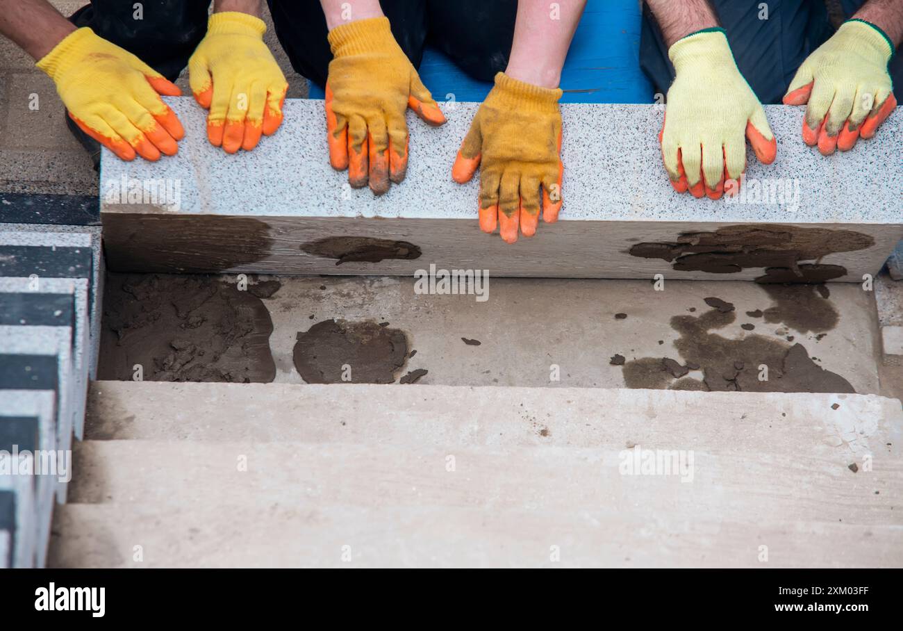 Concrete steps under construction as a team of builders install heavy ...