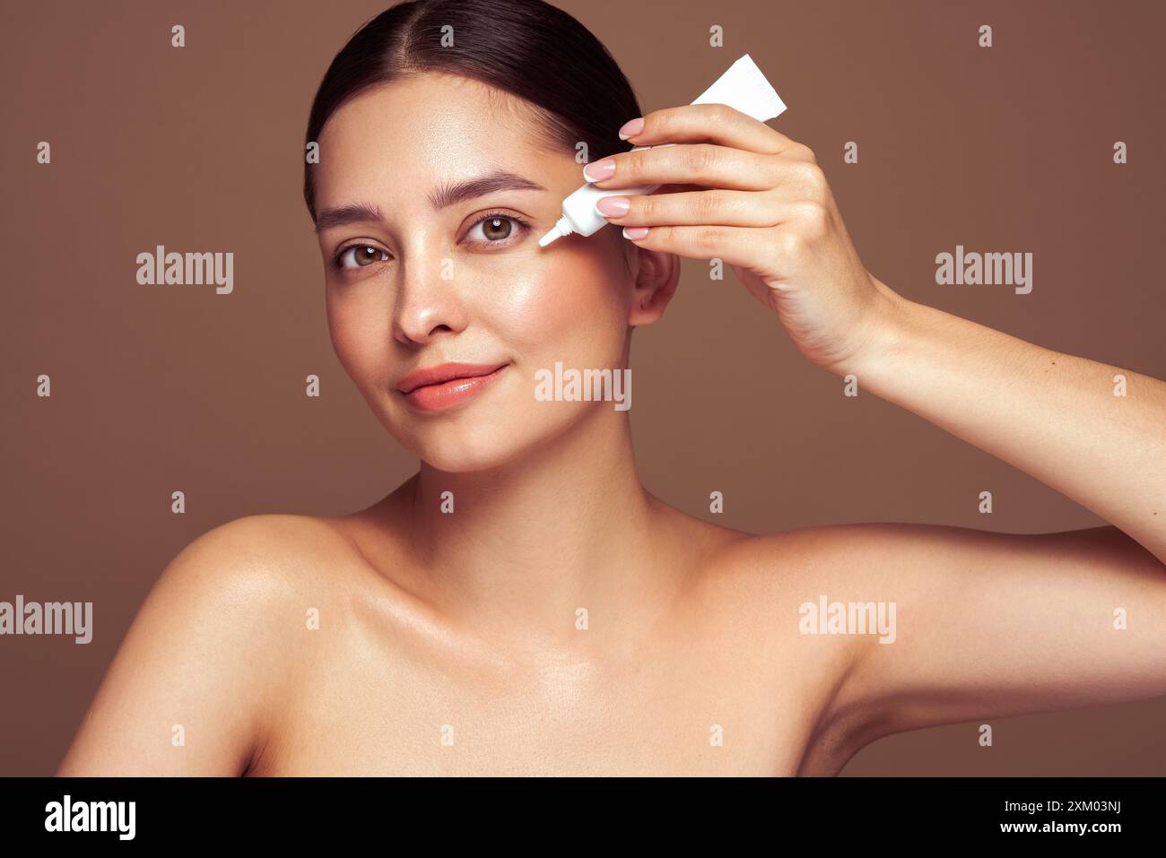 Beautiful woman using cream around the eyes. Video of woman with ...