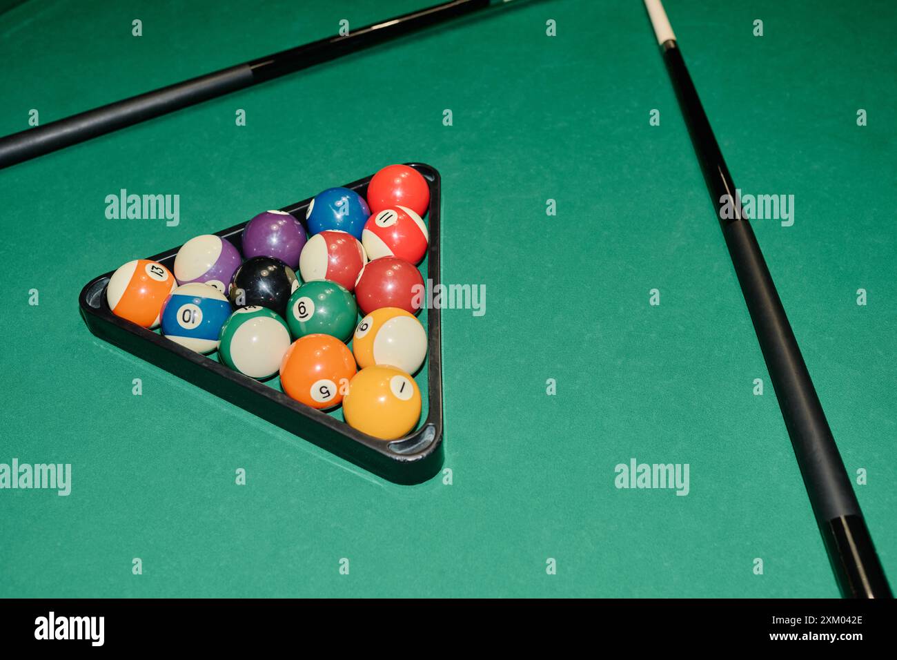 Pyramid of colorful billiard balls in triangle rack placed between ...