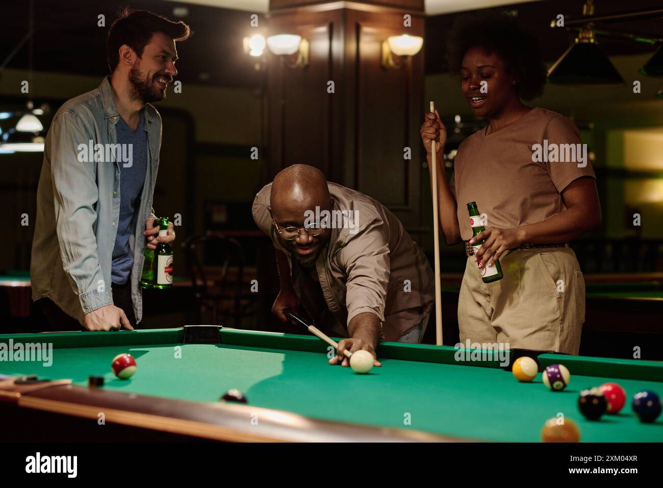 Young African American man standing between two friends and bending ...