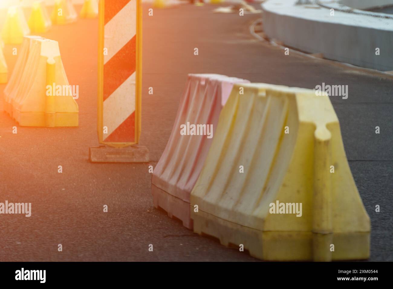 Red, white plastic safety barriers along road. Ensuring road safety ...