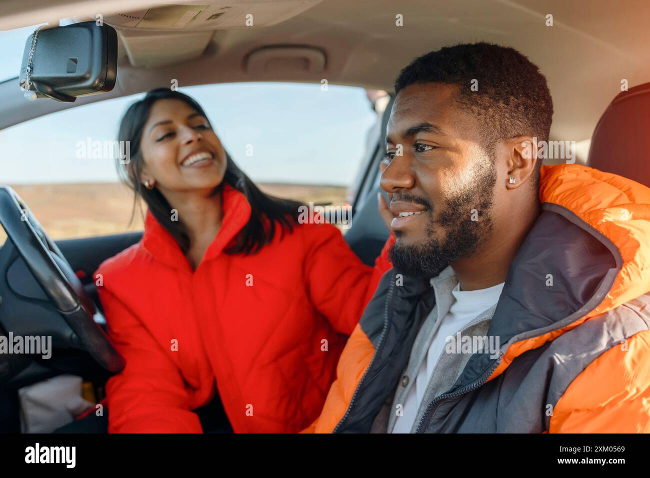 Beautiful happy young loving couple holding hands and smiling while ...