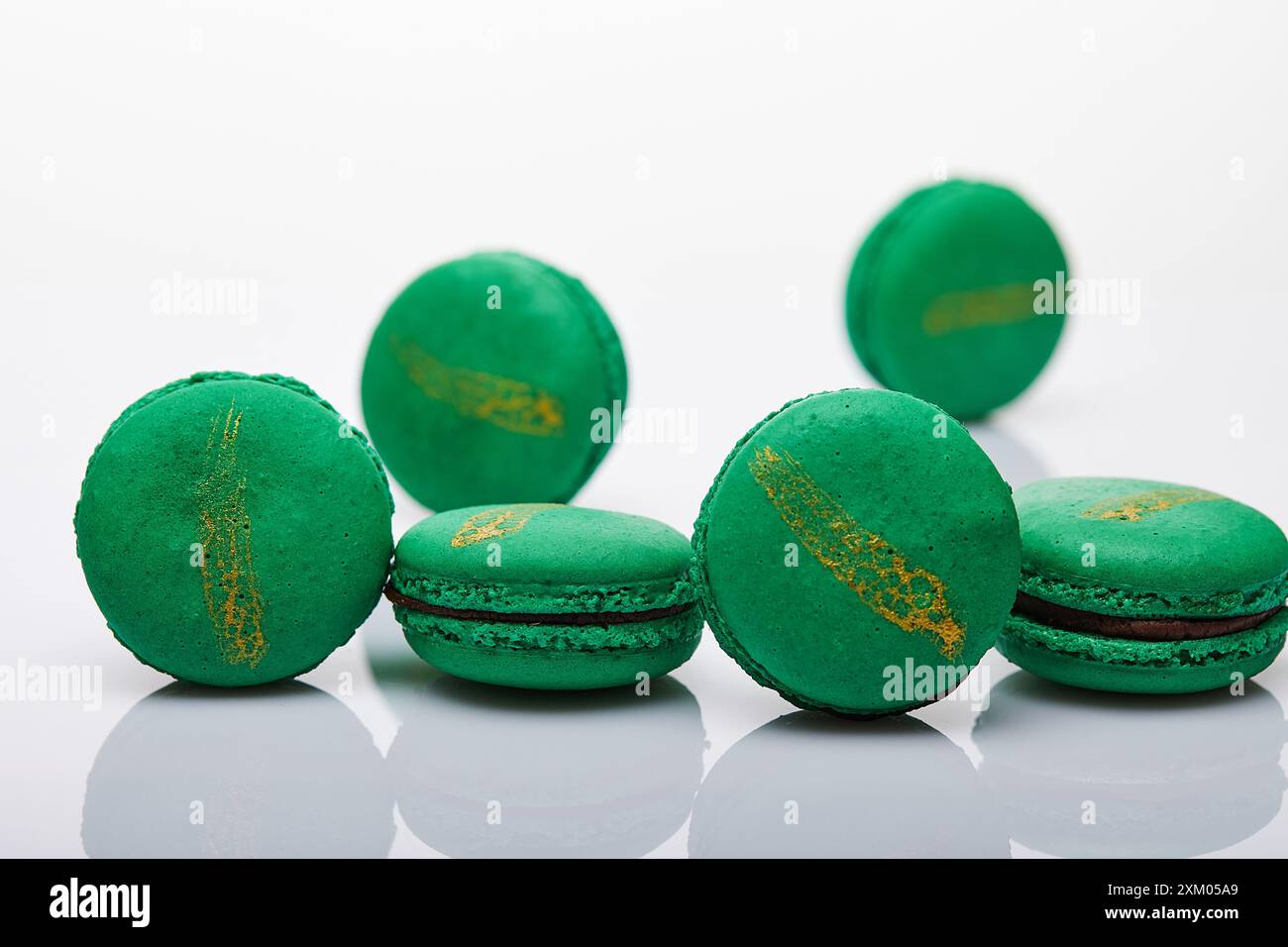 Green macaroni with chocolate filling on a white background with ...