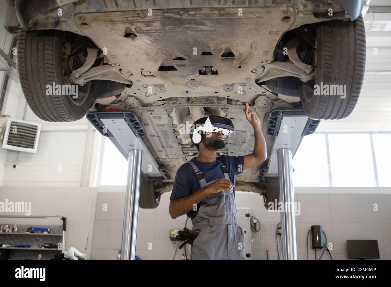Mechanic performs virtual car inspection with advanced technology Stock ...