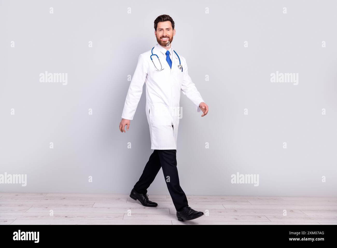 Full body portrait of experienced doctor man walk empty space wear ...
