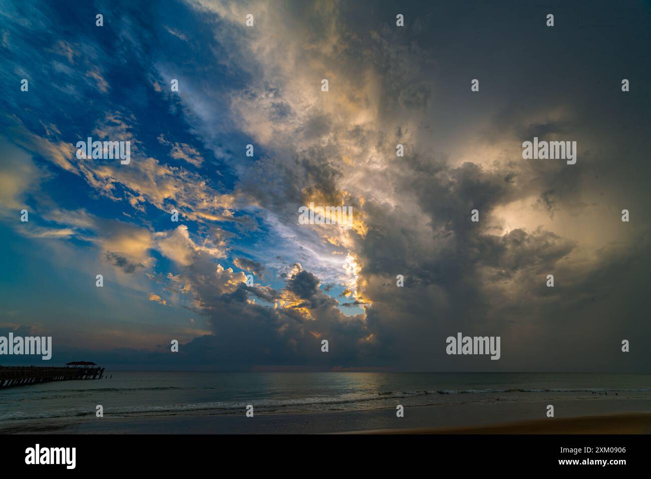 aerial view amazing cloud in colorful sky at sunset above the ocean. The bridge plunges into the ...