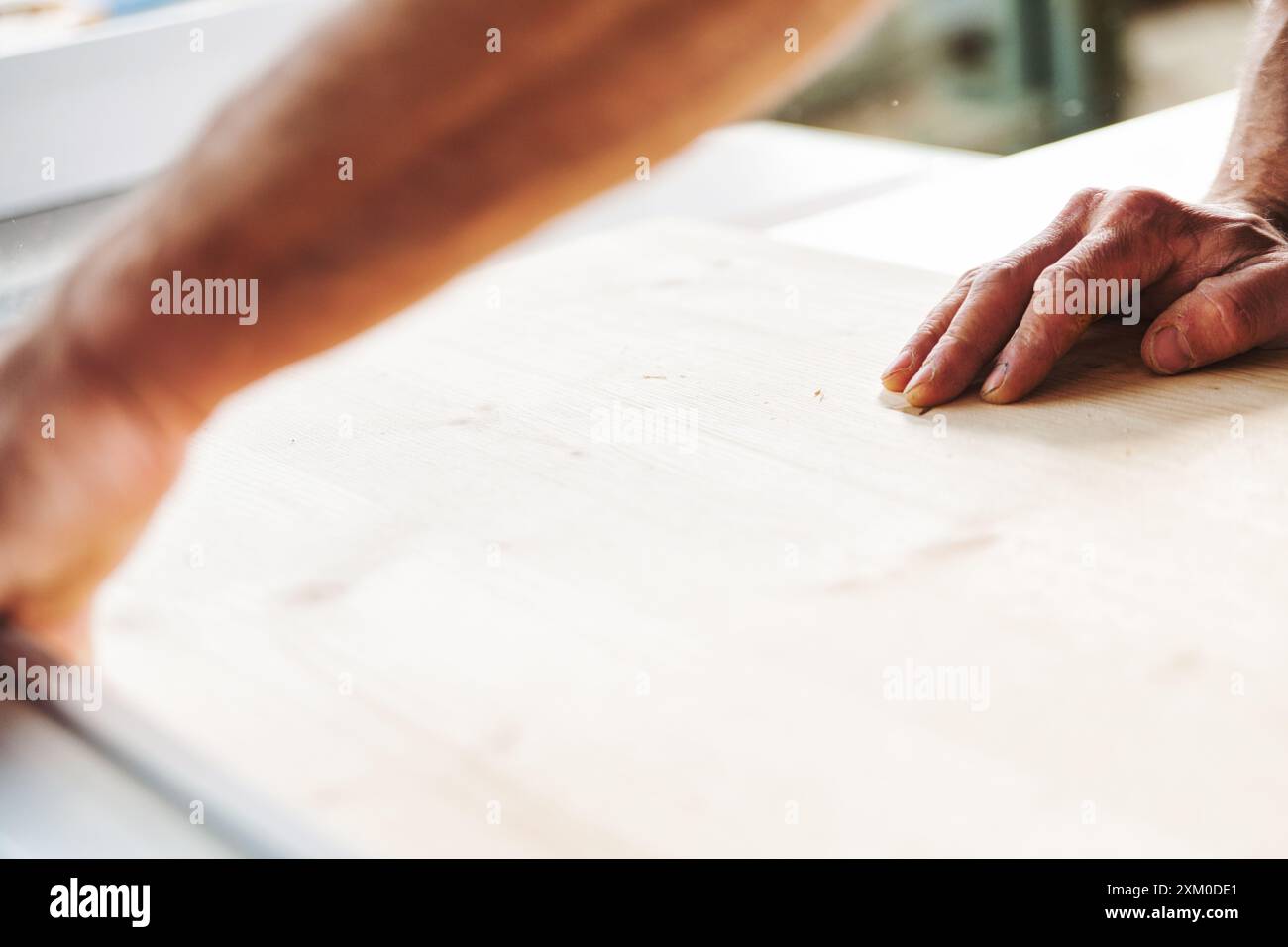 Skilled carpenter smoothing wood in workshop, showcasing precision and ...