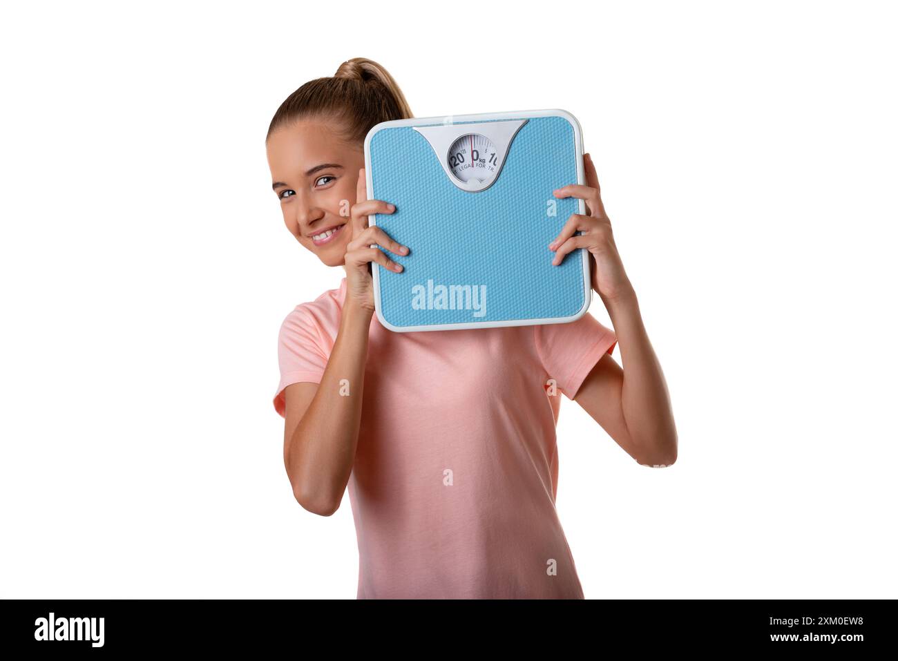 Young attractive smiling girl holding weighing scale and looking to ...