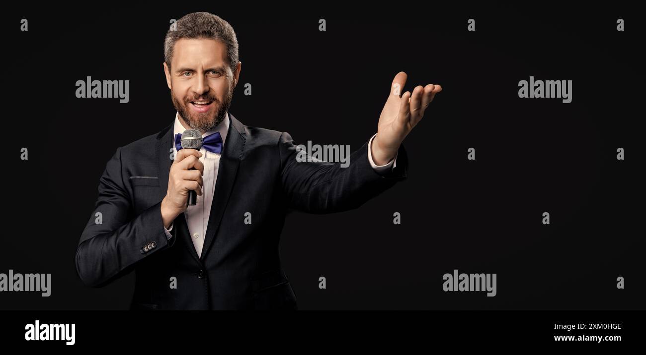 cheerful man presenter in studio. tuxedo man presenter with microphone ...