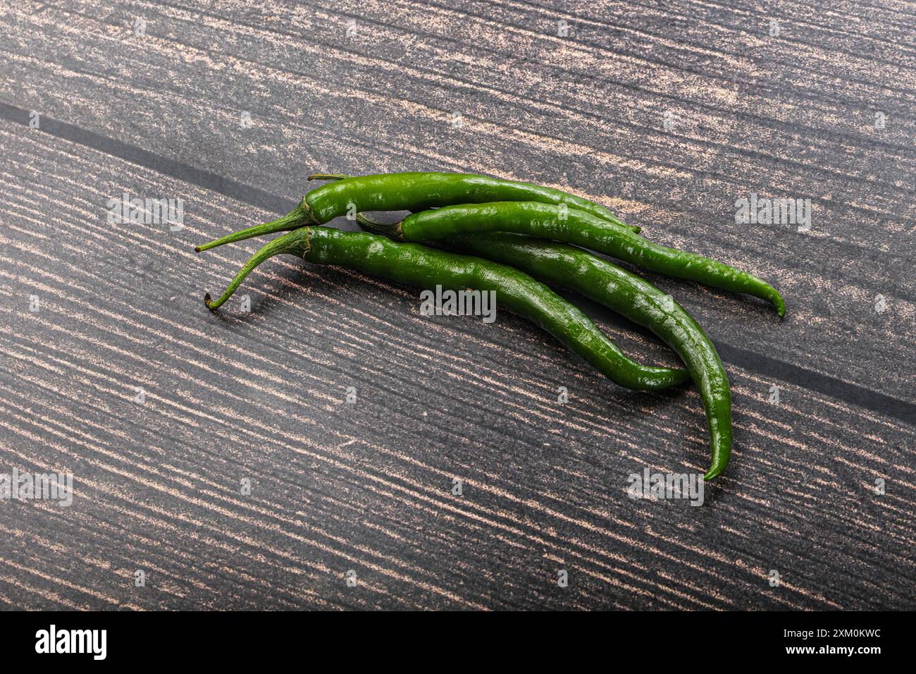Hot and spicy green chili pepper heap Stock Photo - Alamy