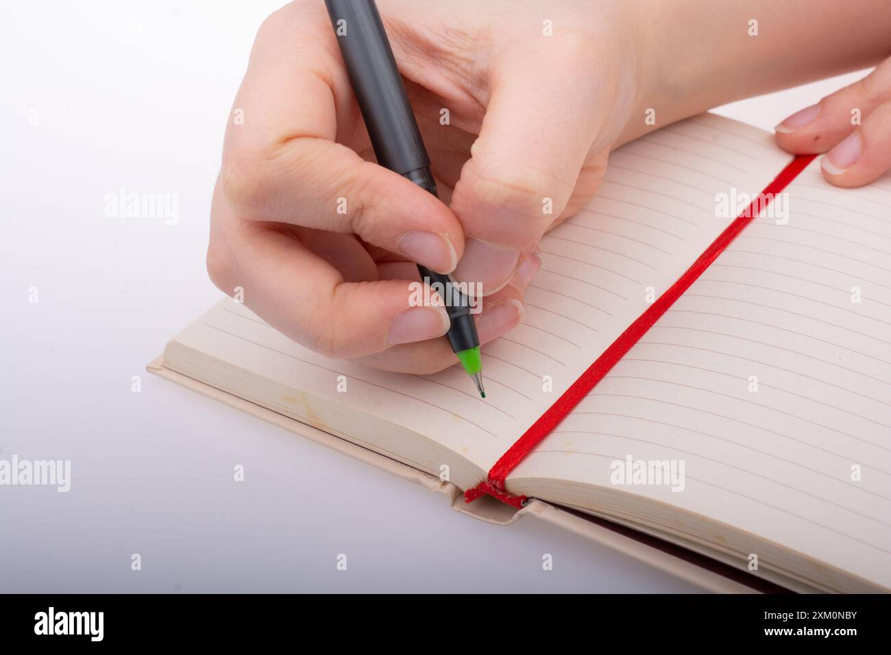 Human hand using pen to write down short note on notebook Stock Photo ...